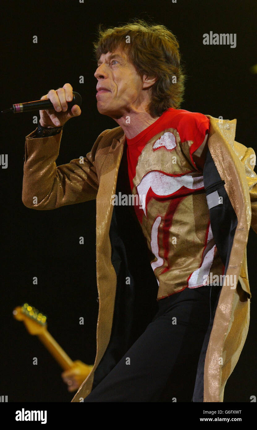 Lead singer Mick Jagger and the Rolling Stones performing on stage ...