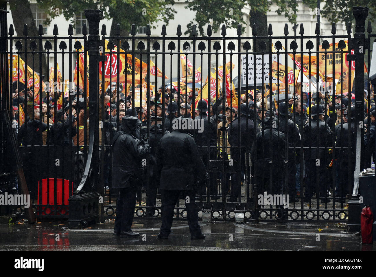 Members of the Fire Brigades Union approach the gates to Downing Street ...