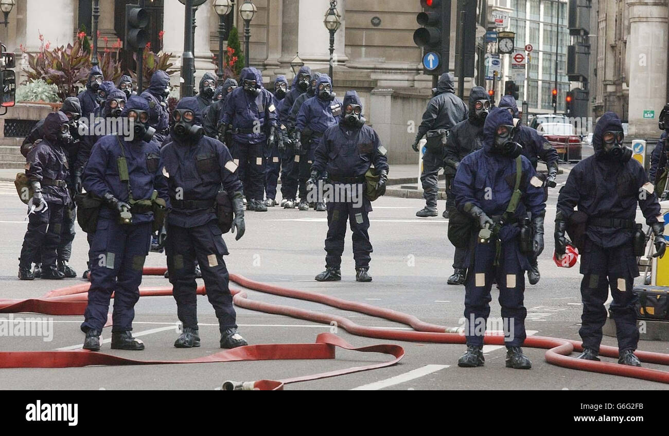 Police officers dressed in Personal Protective Equipment (PPE) attend a ...