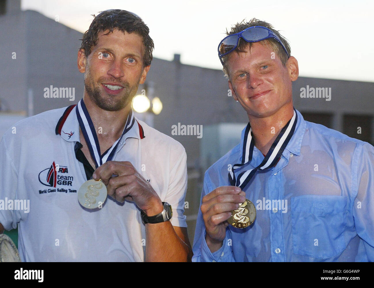 British yachtsmen Simon Hiscocks (left) and Chris Draper hold the gold medals they won in the ...