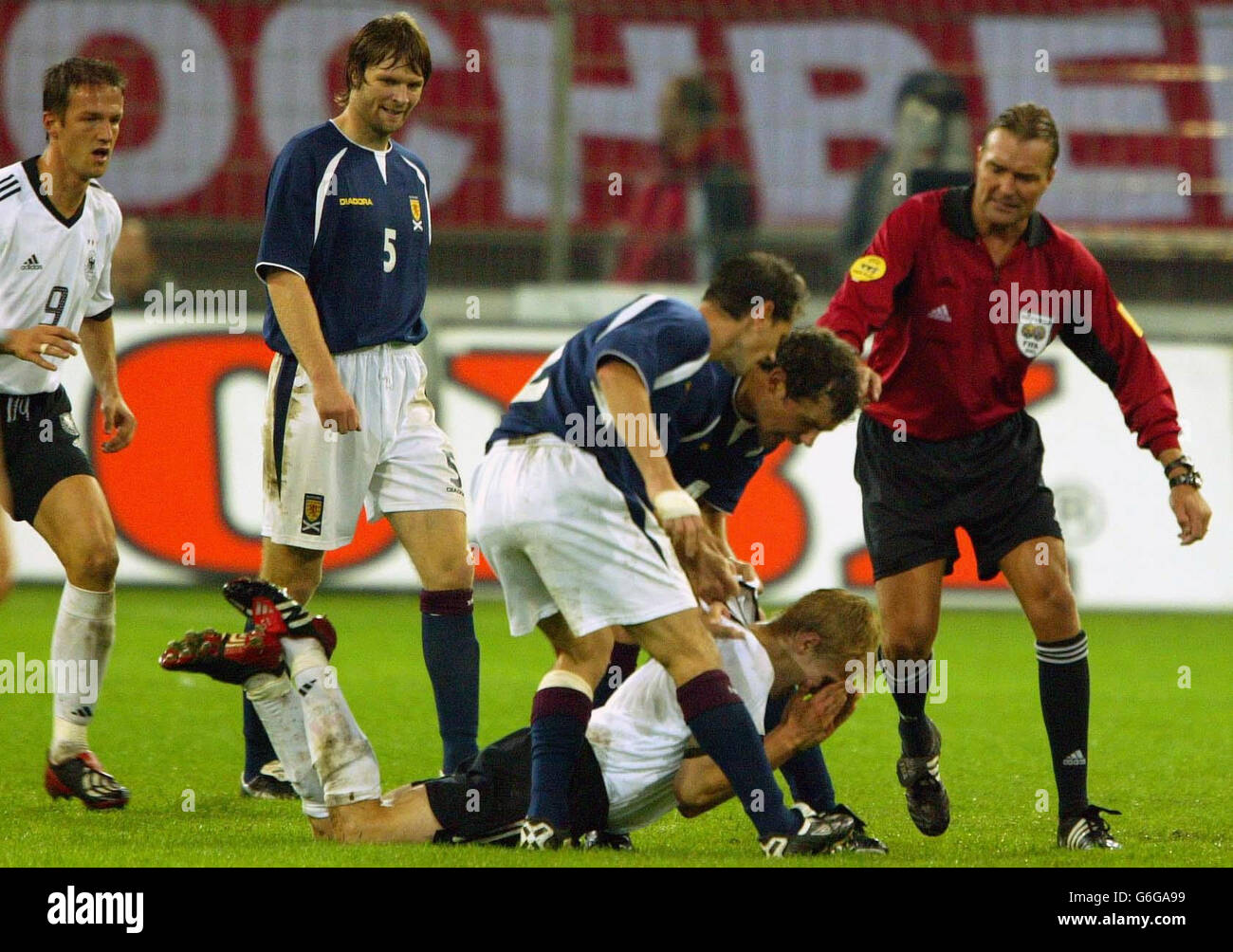 Germany's Tobias Rau is pulled up by the collar of his shirt by ...