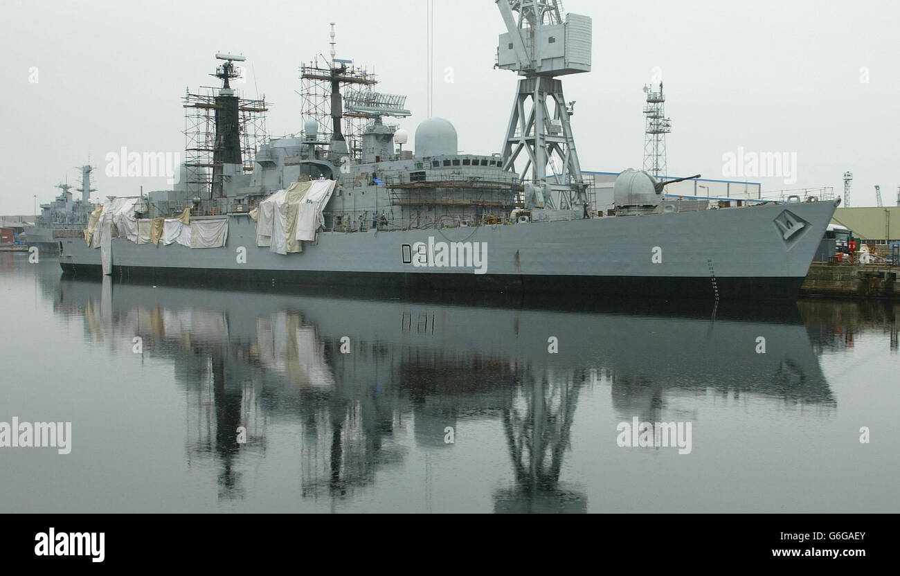 Scaffolding and tarpaulins cover HMS Nottingham at the Royal Navy base ...