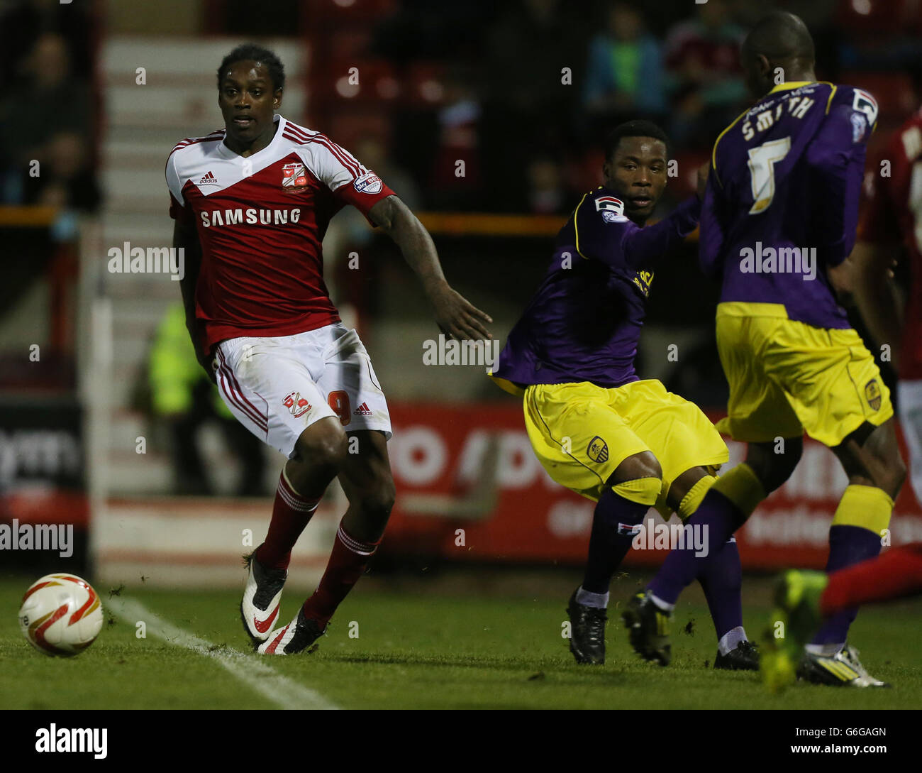 Swindon Town's Nile Ranger holds off Notts County pair Mustapha Dumbuya ...