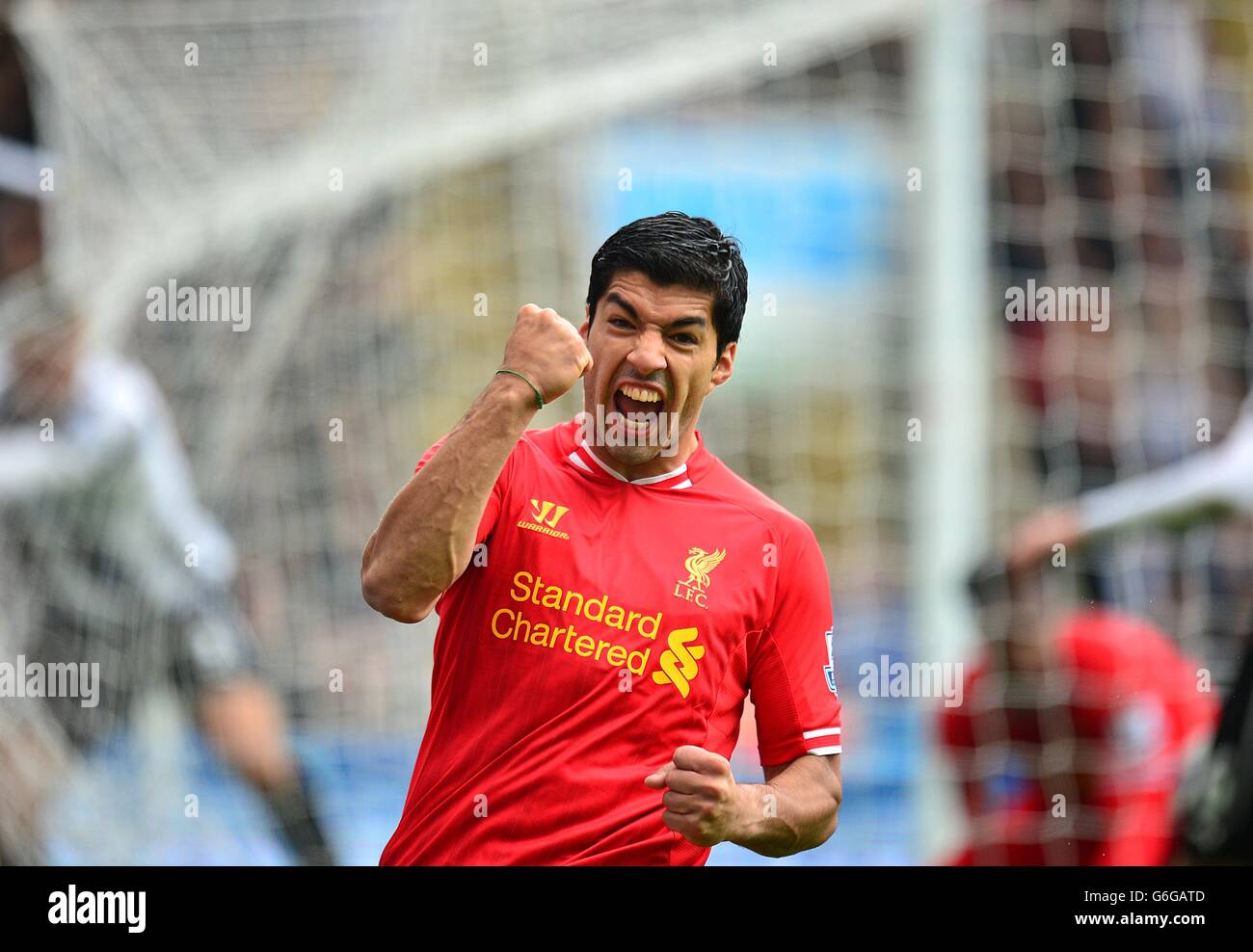 ** Liverpool's Luis Suarez celebrates assisting his side's second goal ...