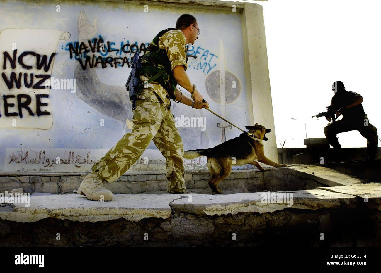 Gunner Simon Stupple with his dog Denzil, as a fellow troop (right ...