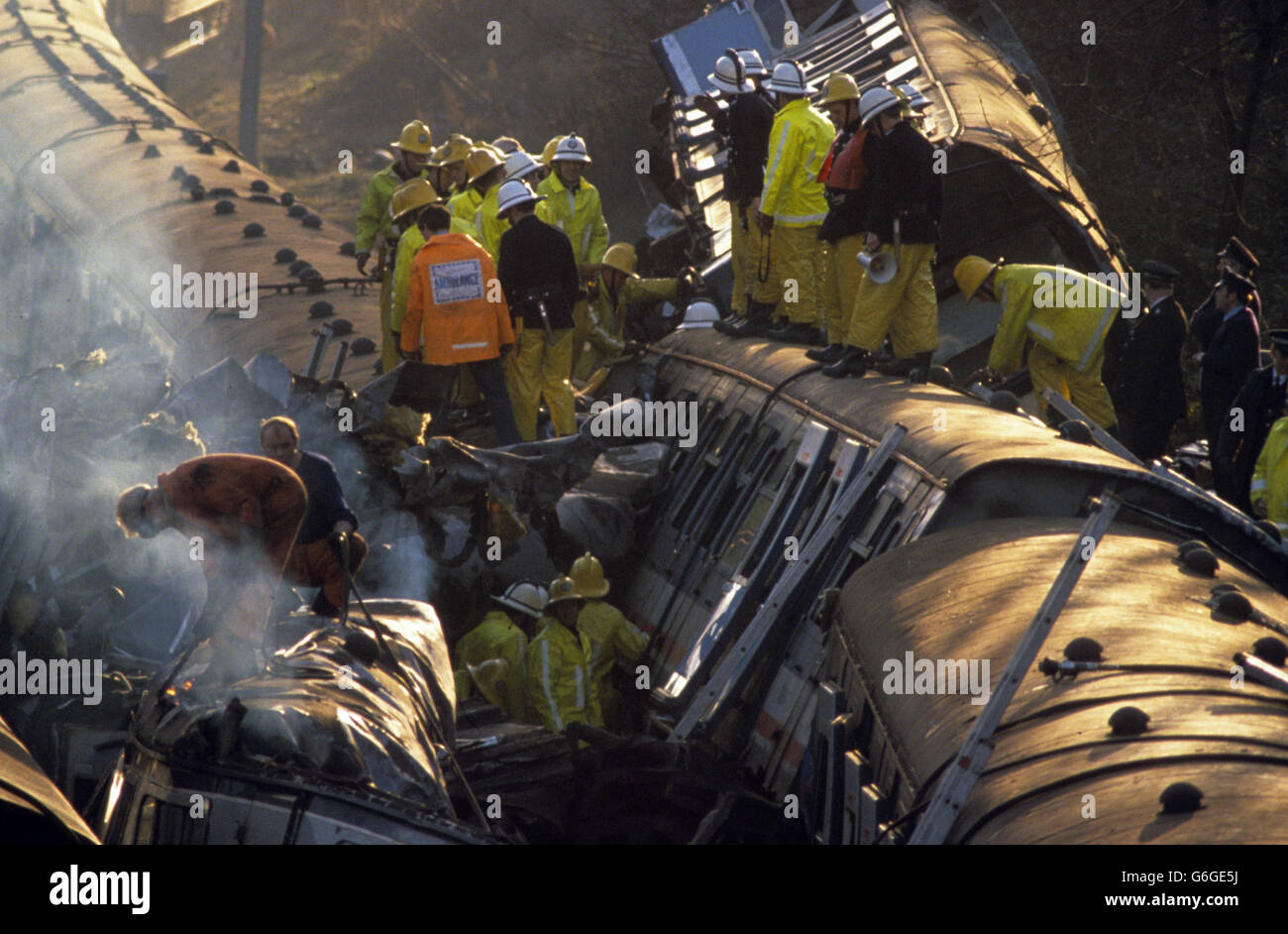Rescue workers clamber over the wreckage of three trains that crashed ...