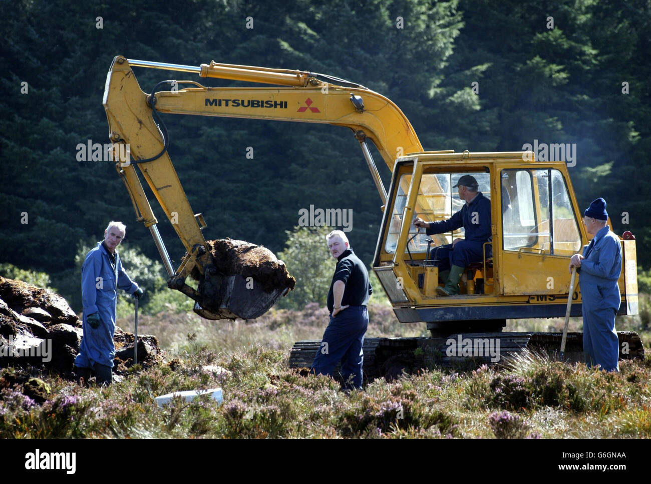 A Garda police officer's study the contents of a bucket, during a dig ...