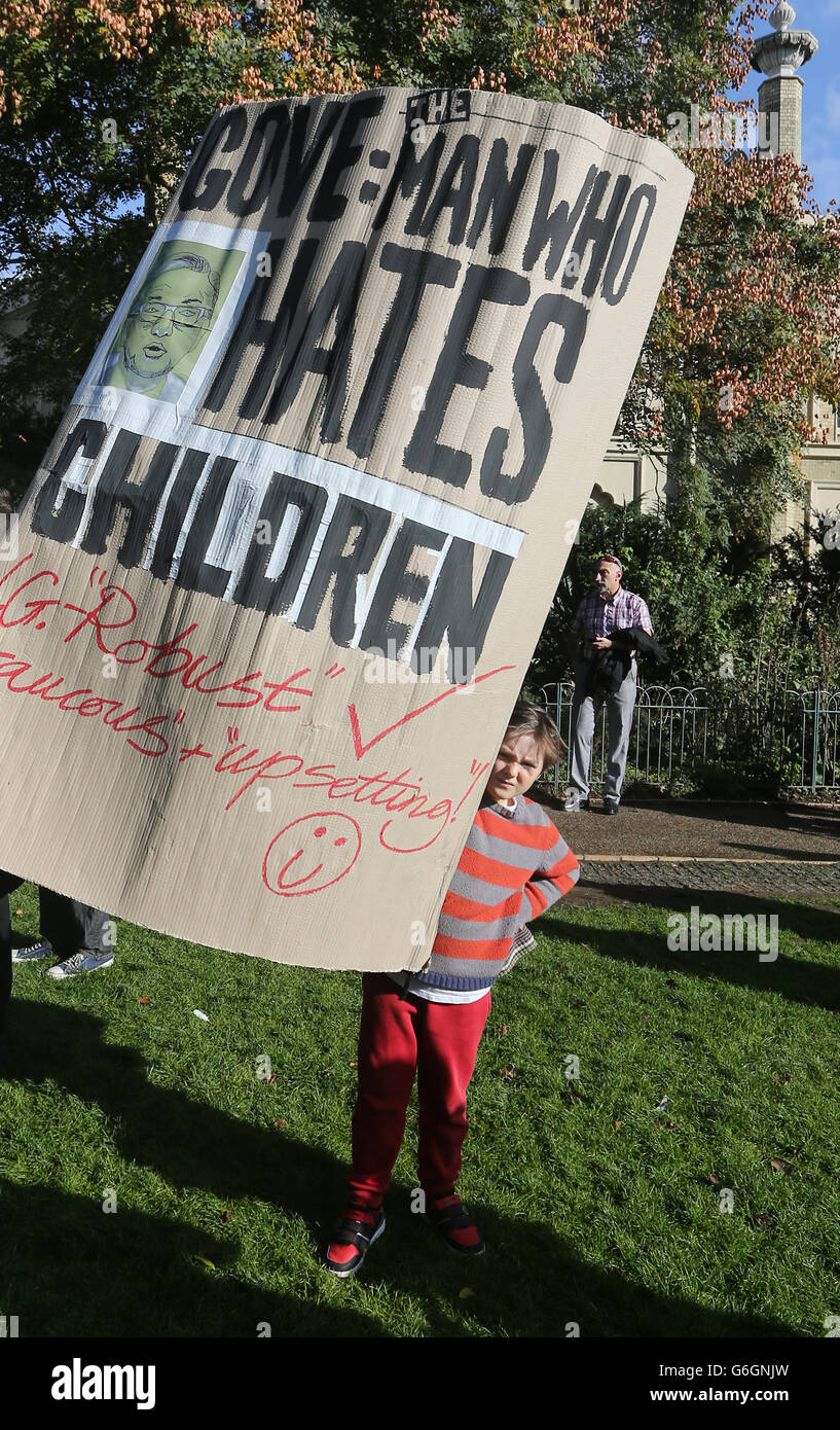 A young boy holds a banner before members of the National Union of ...
