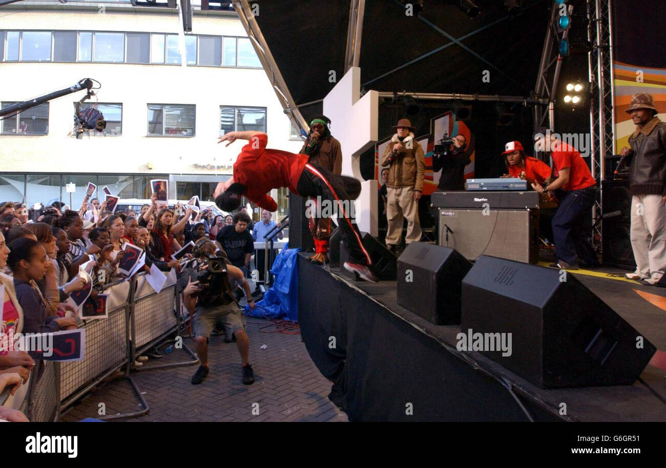 A dancer does a back flip off the stage during a live performance by ...