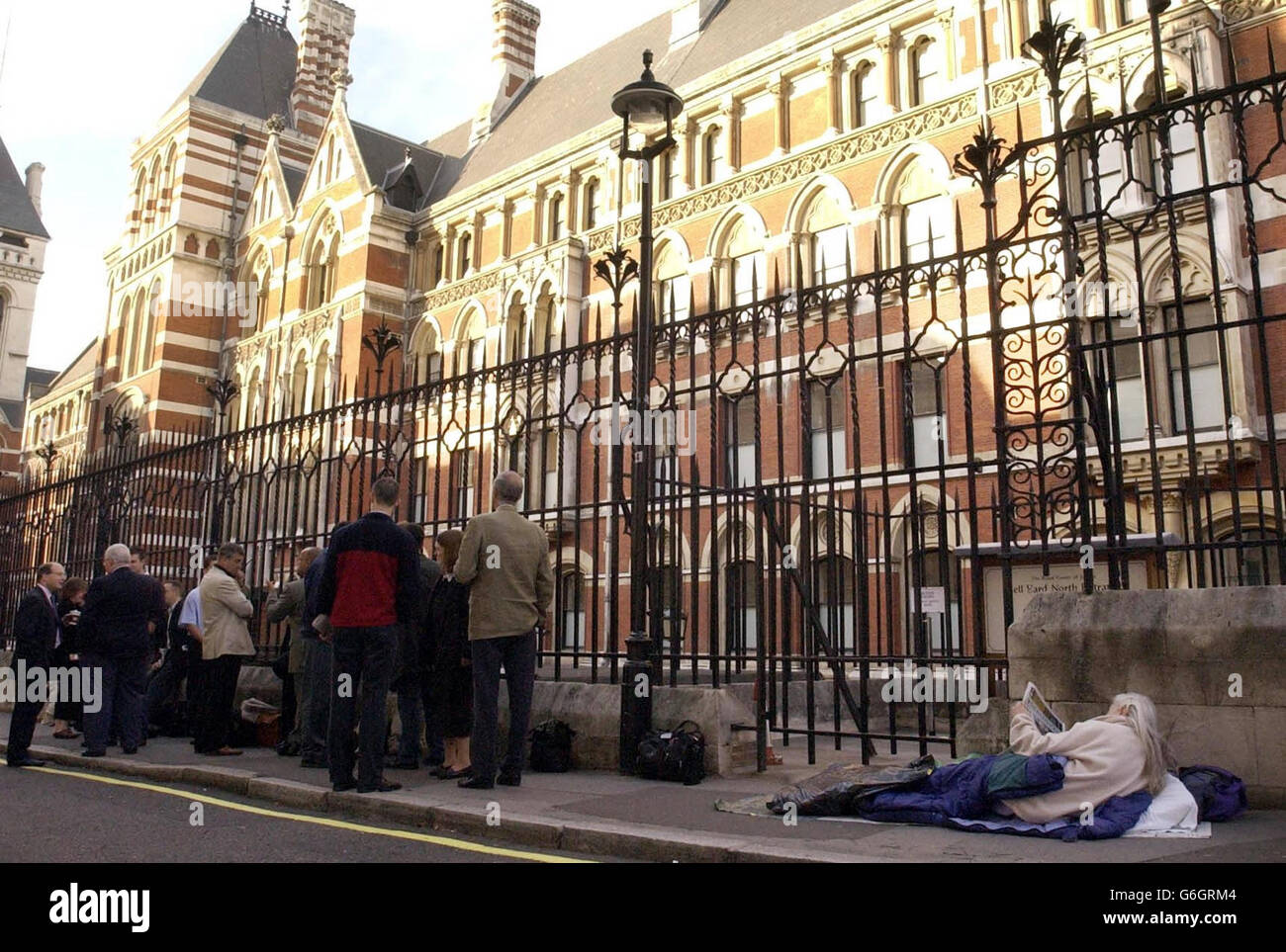 Early risers gather at the gates of the High Court in London where the ...