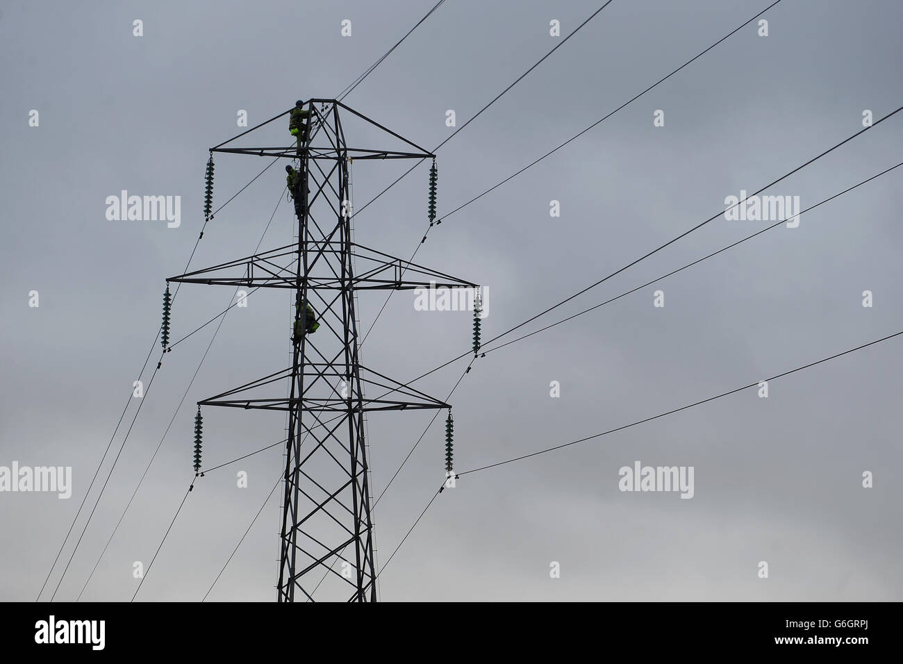 Electricity pylon stock. Workmen climb an electricity pylon to carry ...