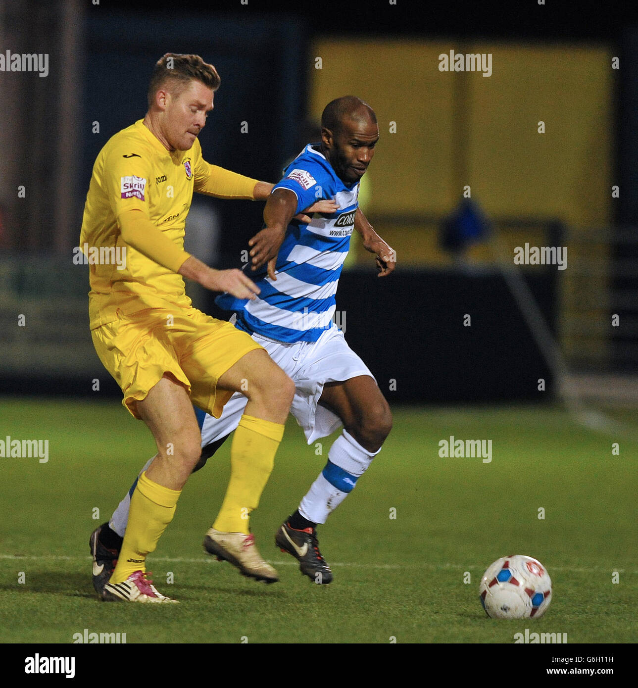 Brackley Town's Elliot Sandy tackle Barrow's Paul Edwards during the FA ...