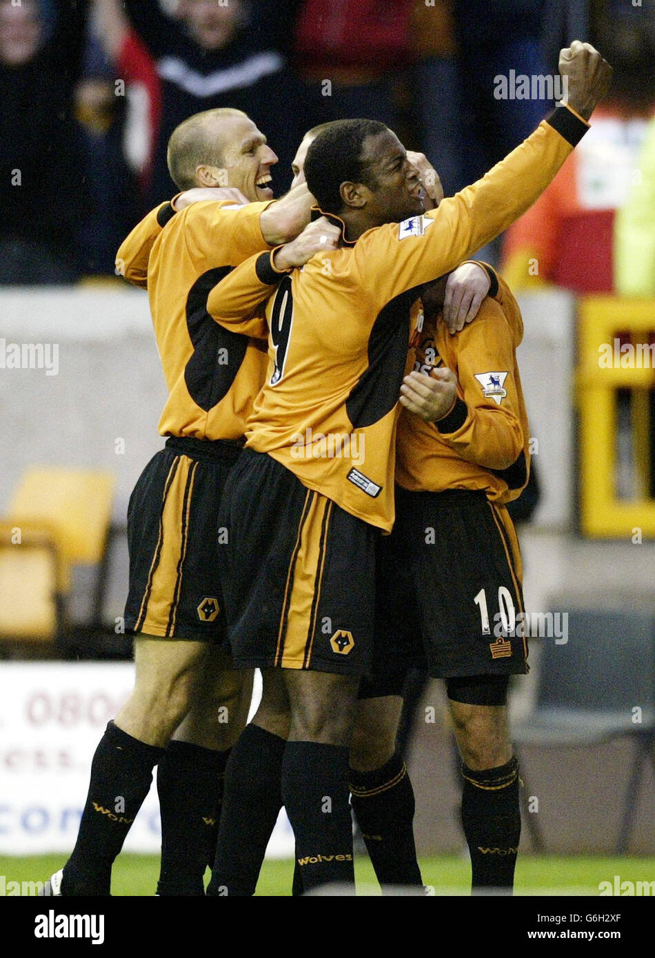Wolverhampton Wanderers' Colin Cameron (right, hidden) is mobbed by ...