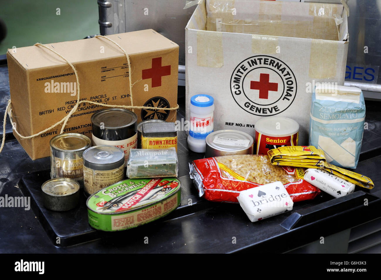 A replica WW2 Red Cross food parcel alongside a modern day equivalent ...
