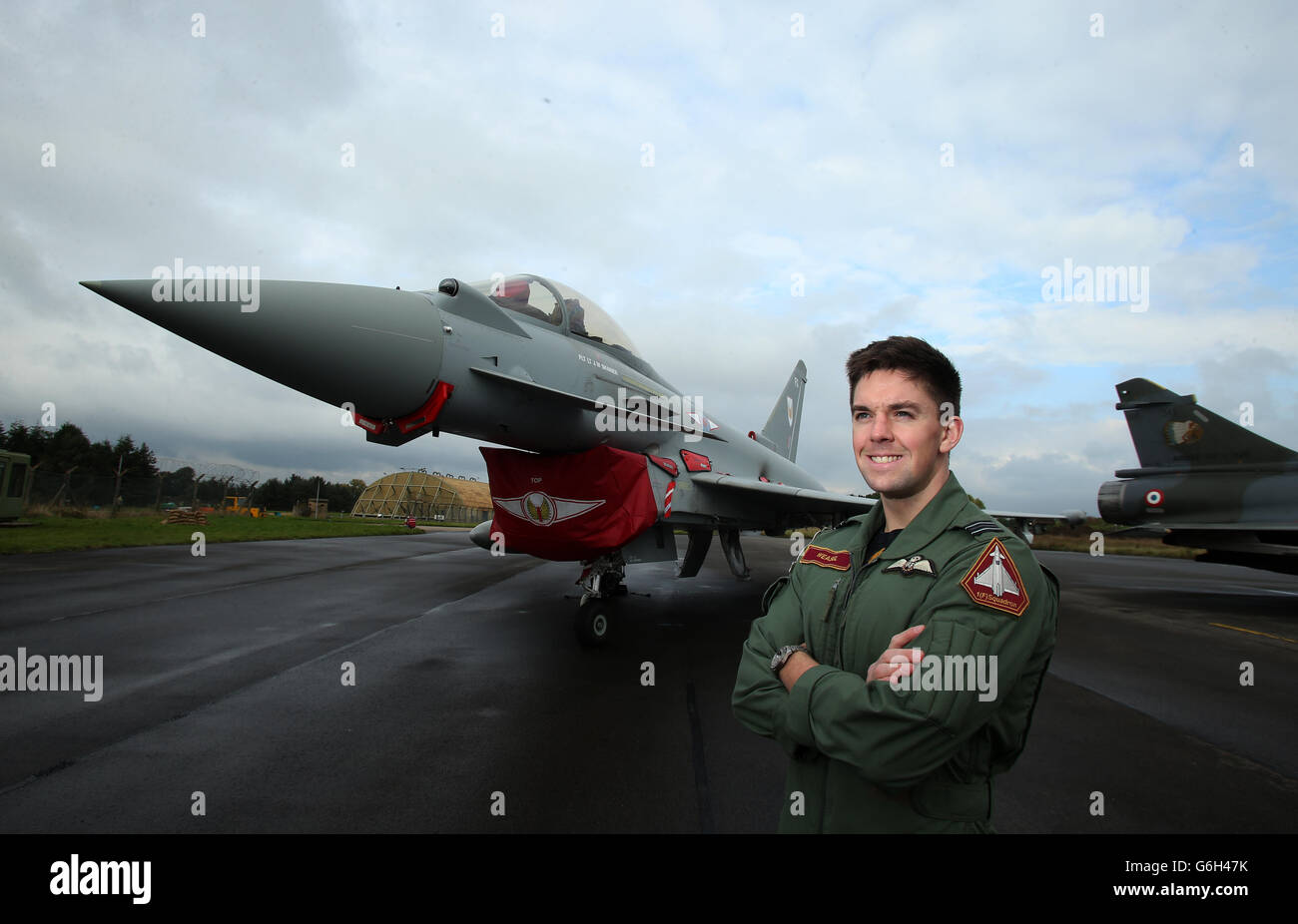 Flt Lt James Harkin from 1(F) Squadron in front of a Typhoon jet during ...