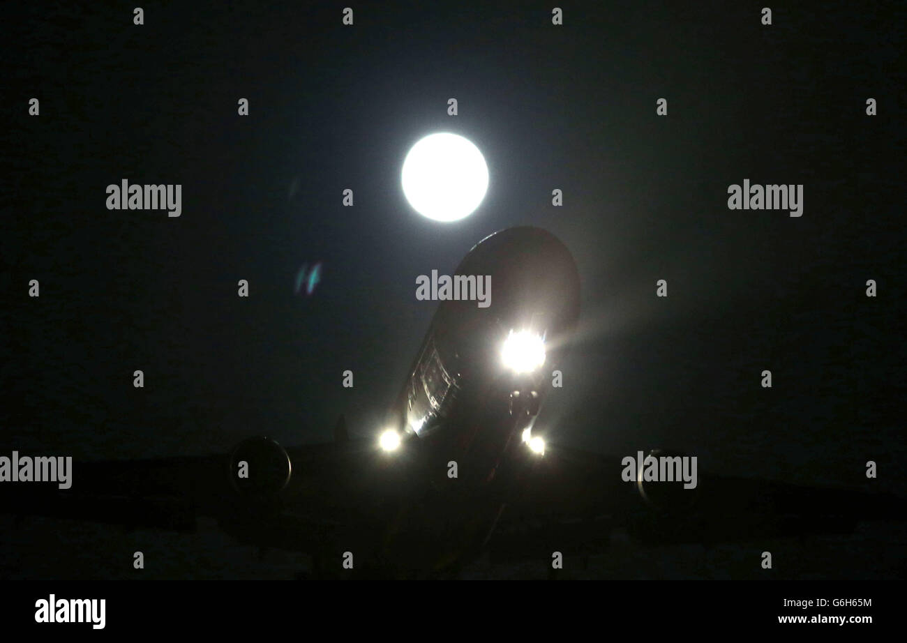 A plane lands in moonlight at Heathrow Airport, London Stock Photo - Alamy