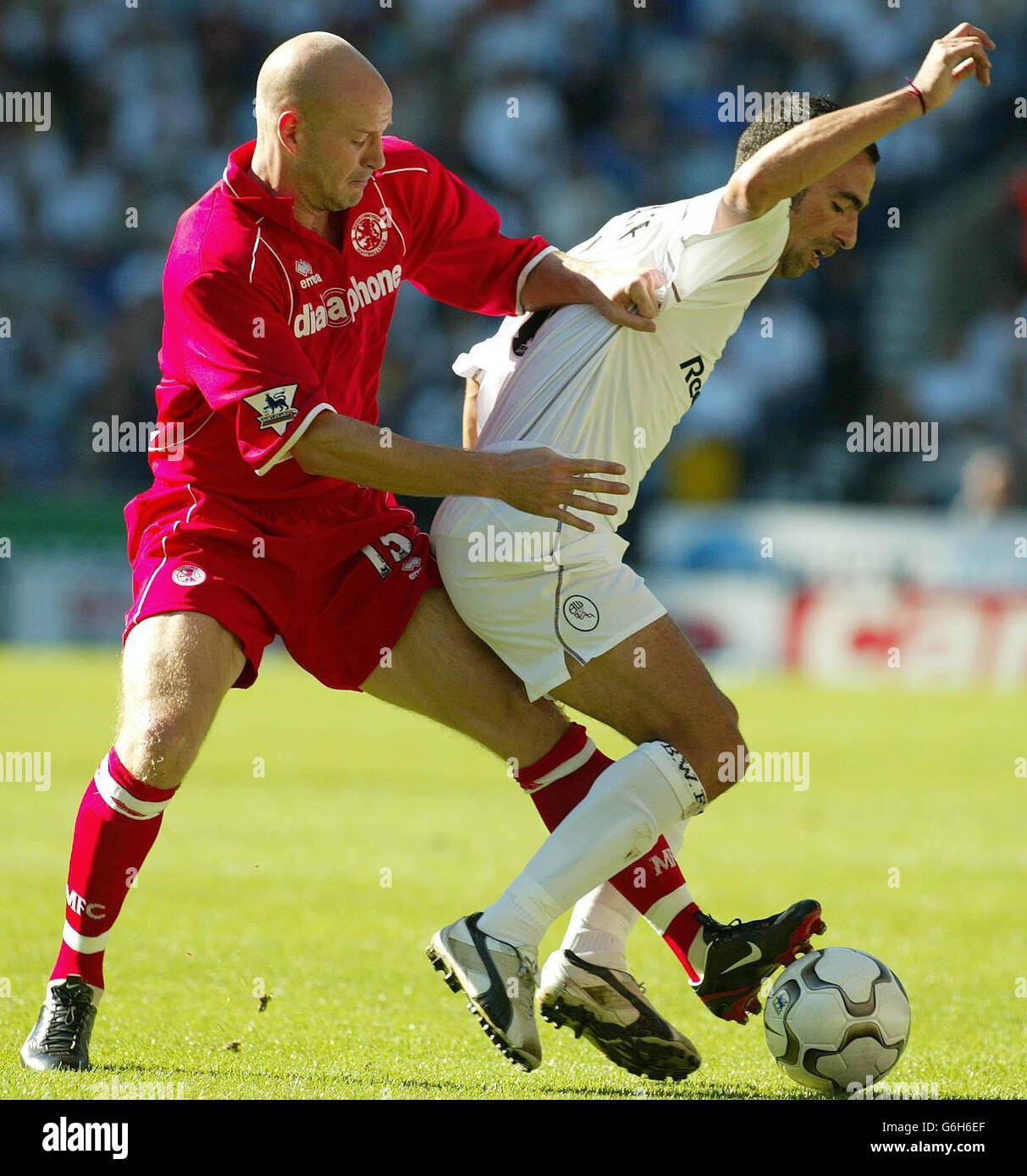 Middlesbrough's Danny Mills (left) tussles with Bolton's Youri ...
