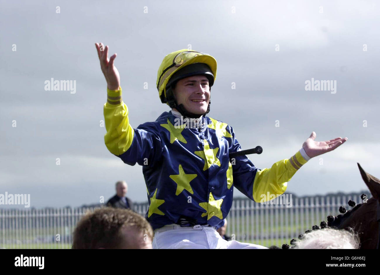 Jockey Pat Smullen celebrates in the winners enclosure after winning on ...
