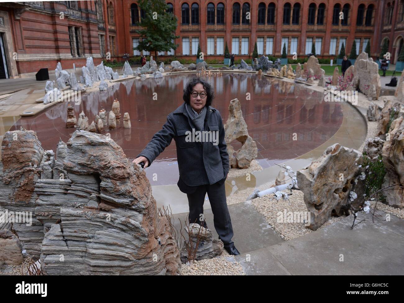 Chinese artist Xu Bing stands alongside his new installation at the V&A ...