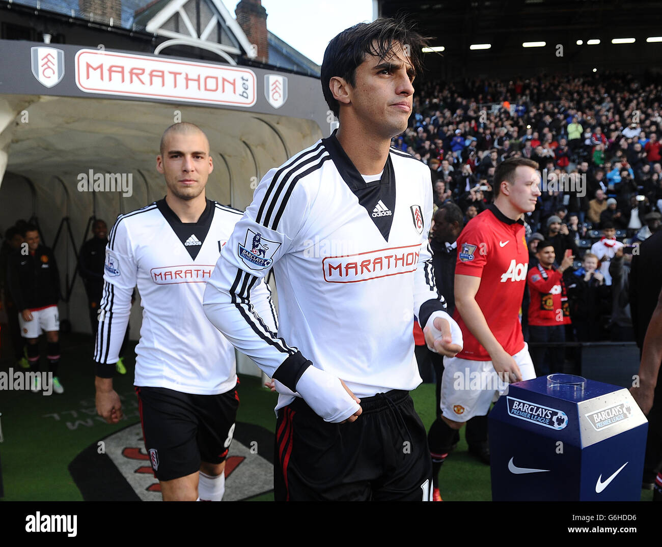 Pajtim Kasami (left) and Bryan Ruiz (centre) of Fulham and Phil Jones ...