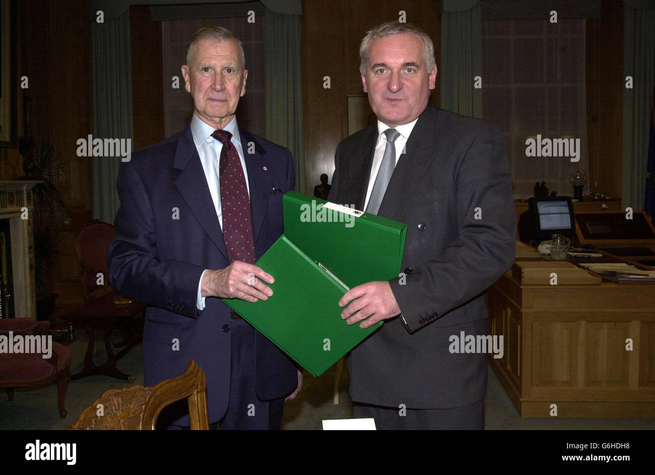 Judge Peter Corey (left) hands two reports into the murders of Lord and ...