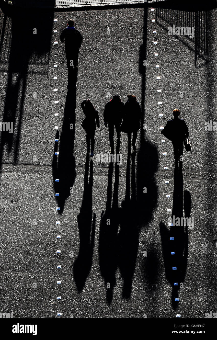 Long shadows are cast in the Autumn sunshine as people cross Lothian ...