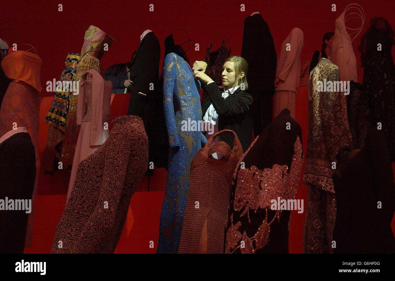 Chief dresser Erica Svec gives the finishing touches to one of the dresses which was worn by ...