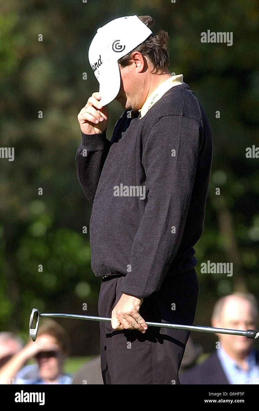 South Africa's Tim Clark hides his face after missing a putt on the ...