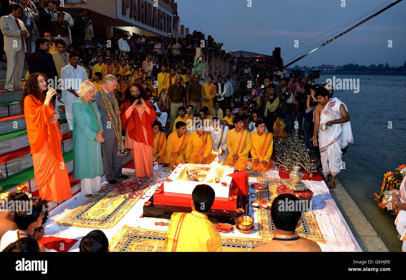 The Prince of Wales and Duchess of Cornwall study a fire during their ...