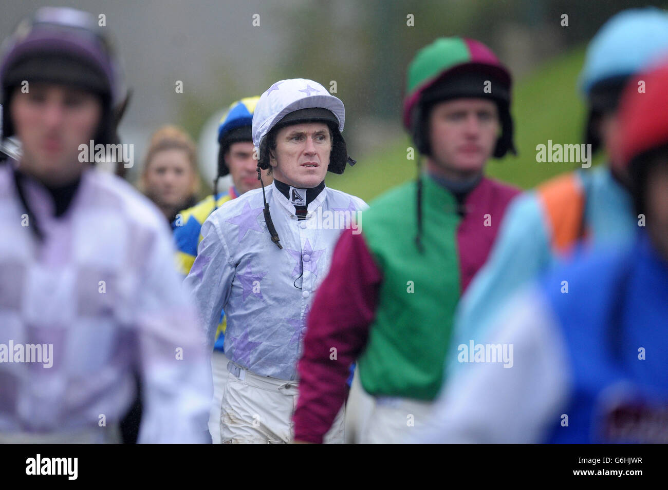 Tony McCoy (centre) enters the parade ring before riding Minella for ...