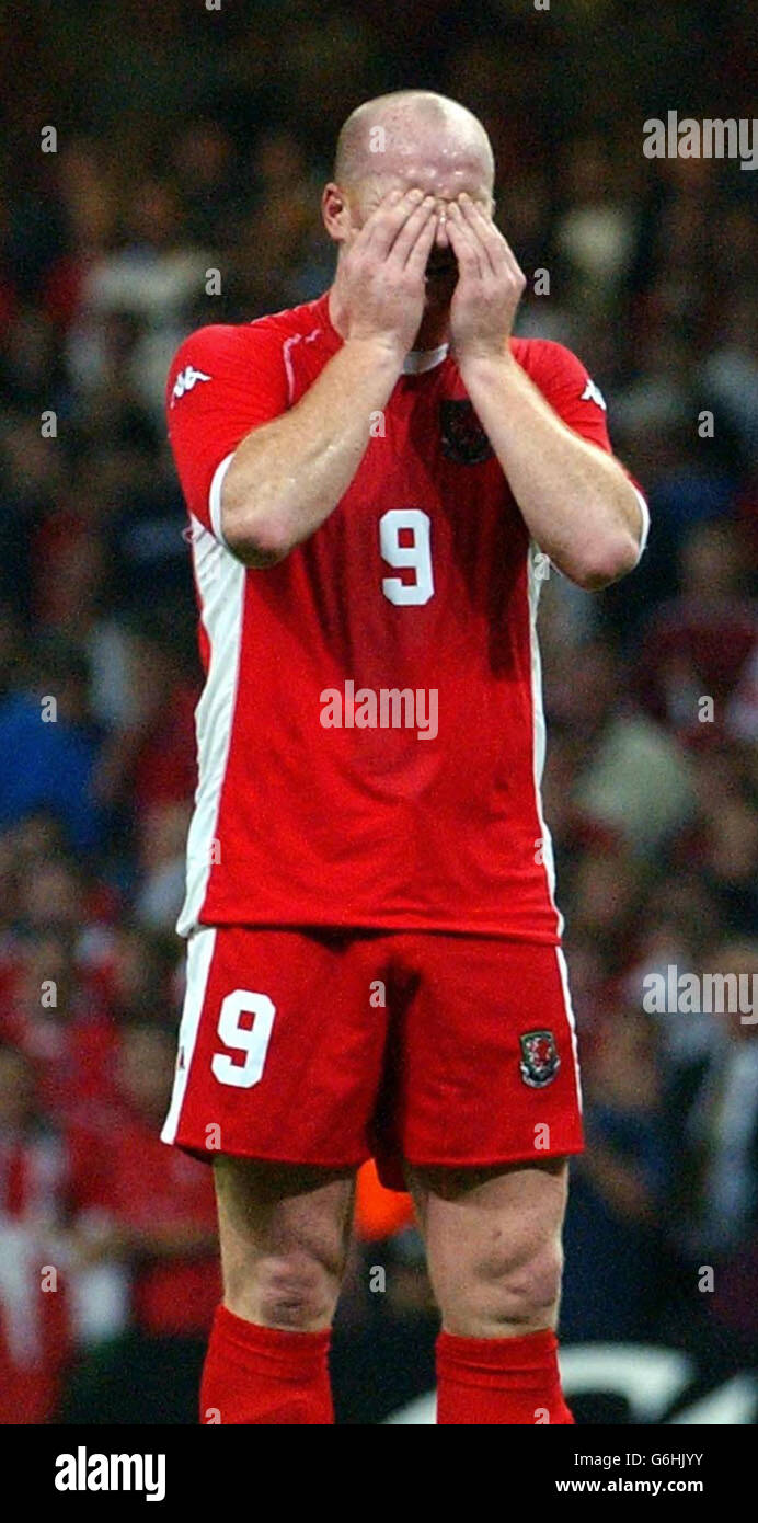 EDITORIAL USE ONLY. John Hartson of Wales rubs his eyes after Serbia ...