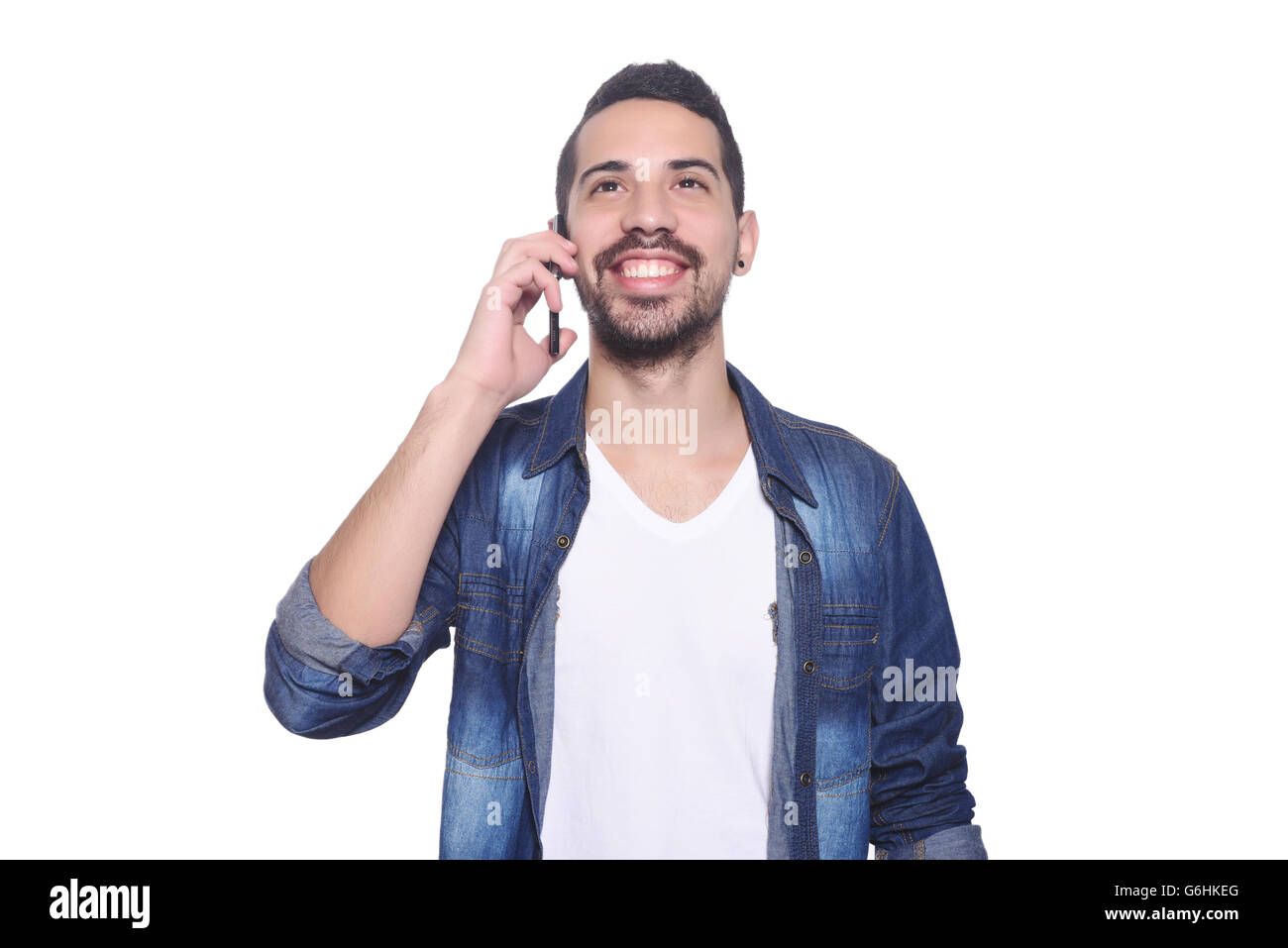 Portrait of attractive young man talking on his phone. Isolated white ...
