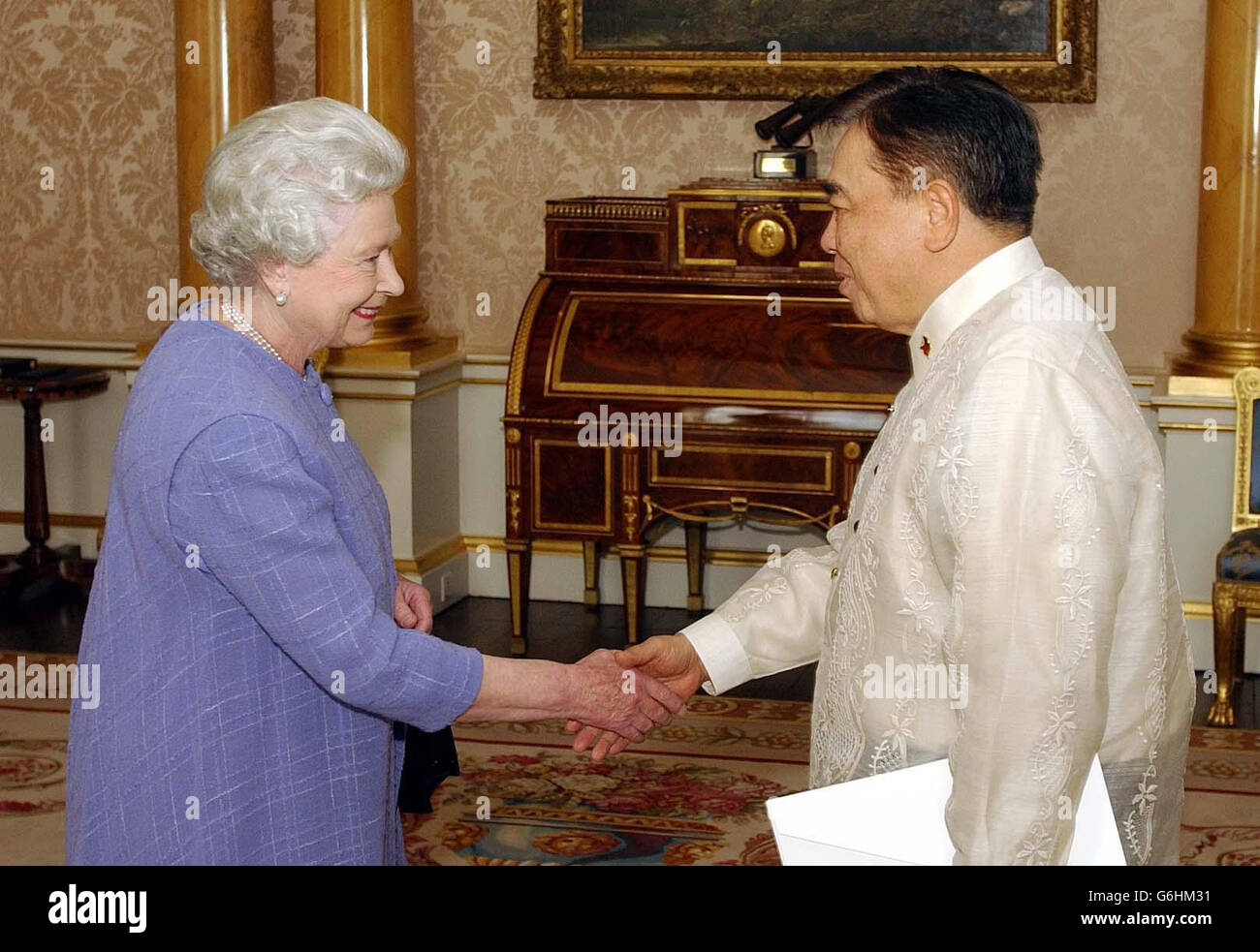 Britain's Queen Elizabeth II shakes hands with the Ambassador of the ...
