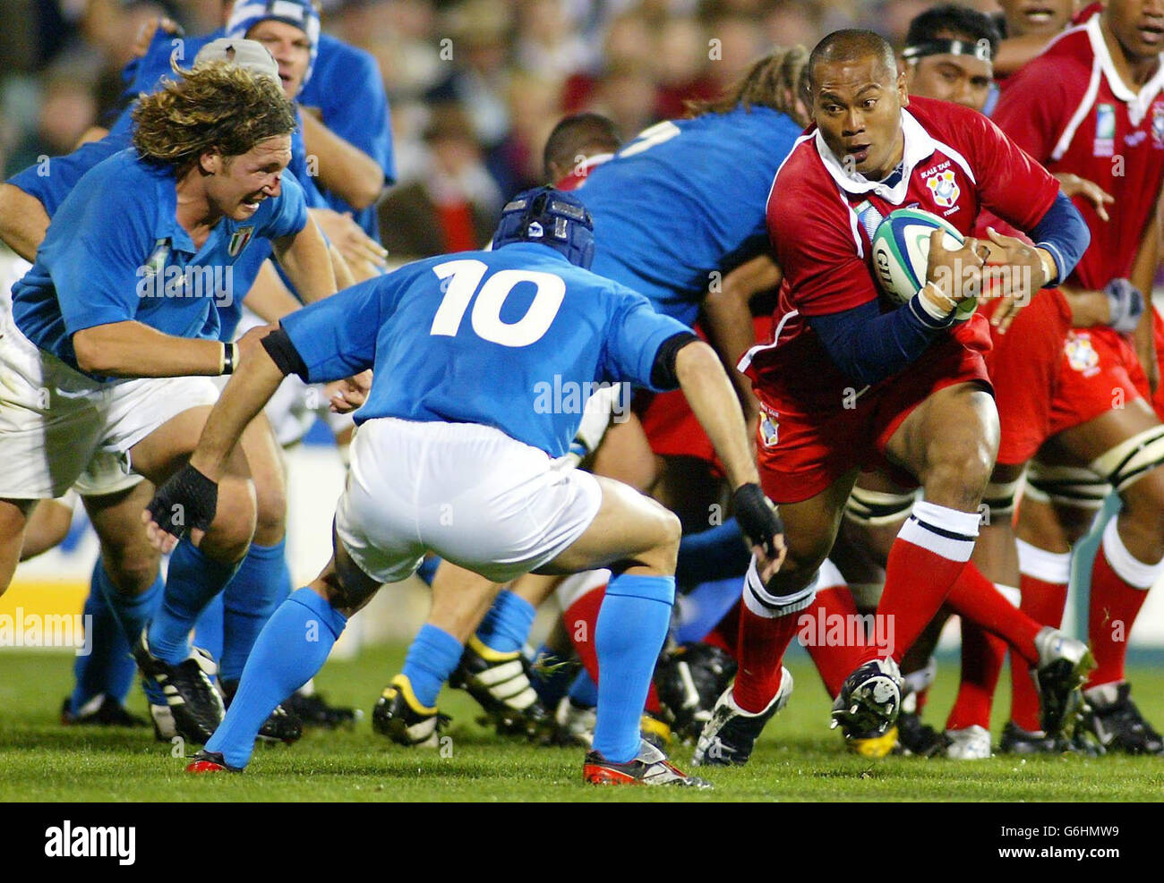 Tonga's ViIiami Ma'asi (right) gets past Italy's Rima Wakarua during ...