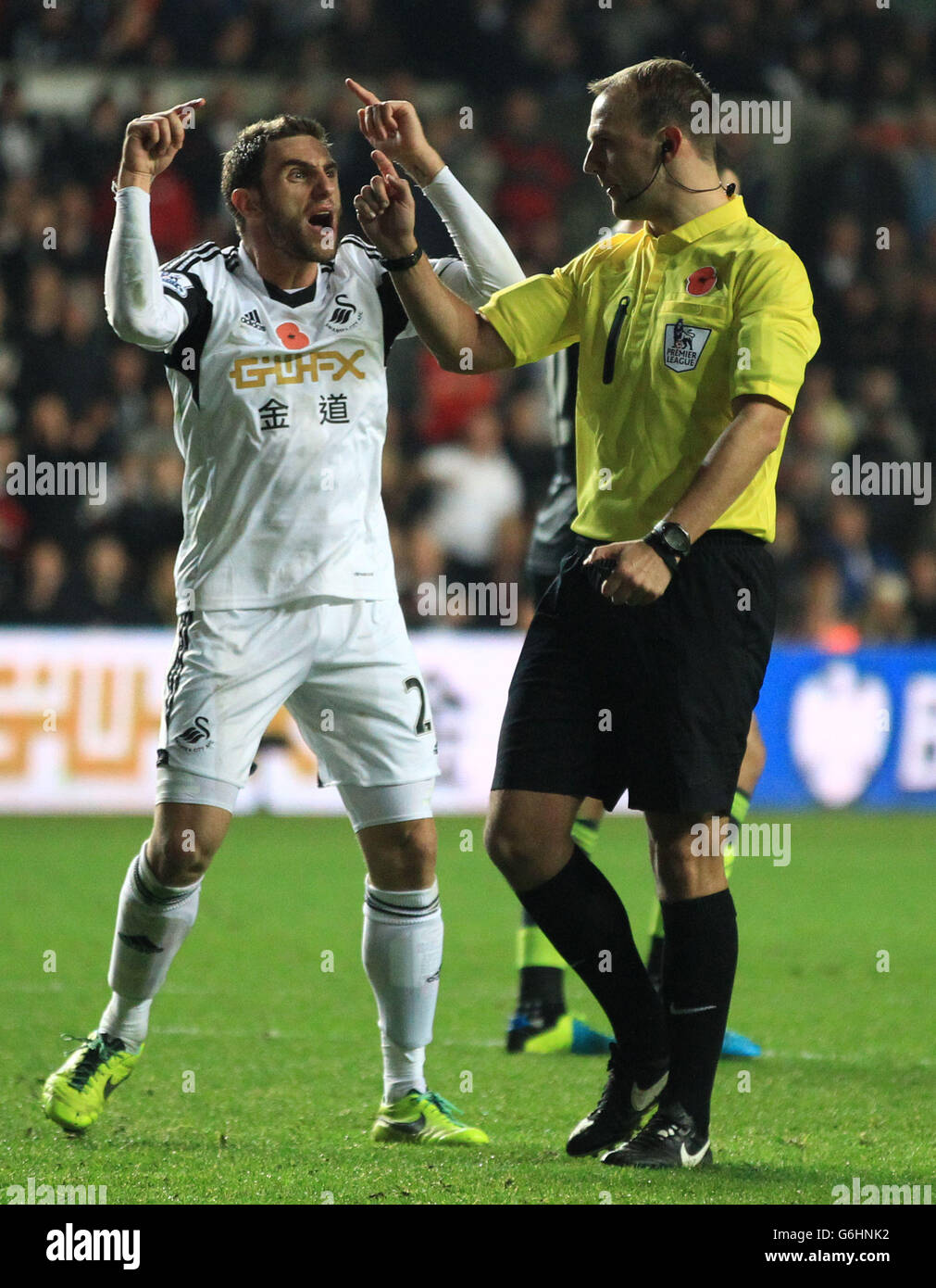 Swansea City's Angel Rangel shows his anger at referee Richard Madely ...