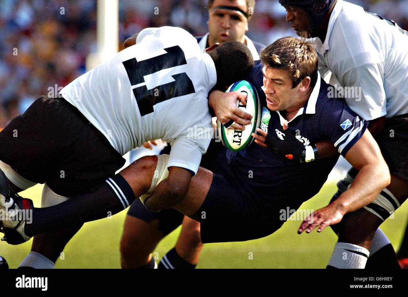 Scotland`s Nathan Hines holds off Fiji`s Rupeni Caucau during their ...