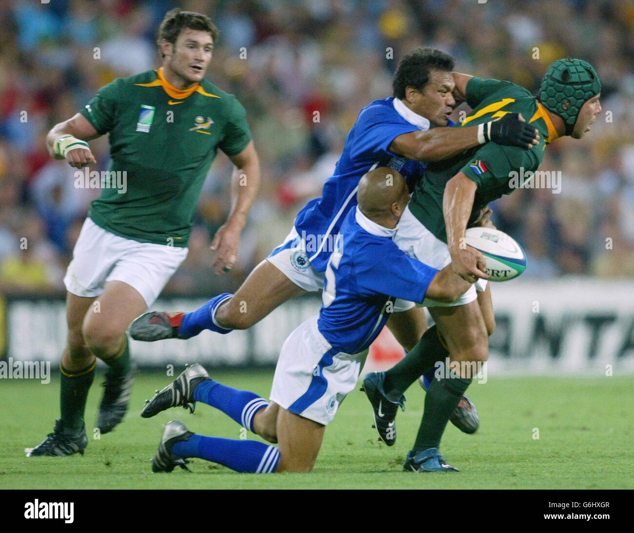 South Africa's De Wet Barry is tackled by Samoa's Brian Lima and Tanner ...