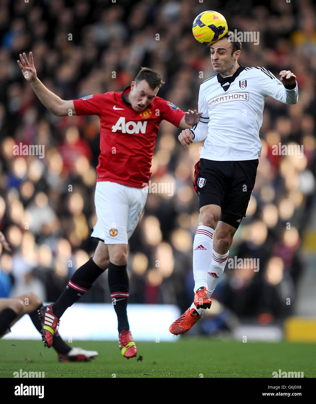 Fulham's Dimitar Berbatov (right) and Manchester United's Phil Jones battle for the ball Stock ...