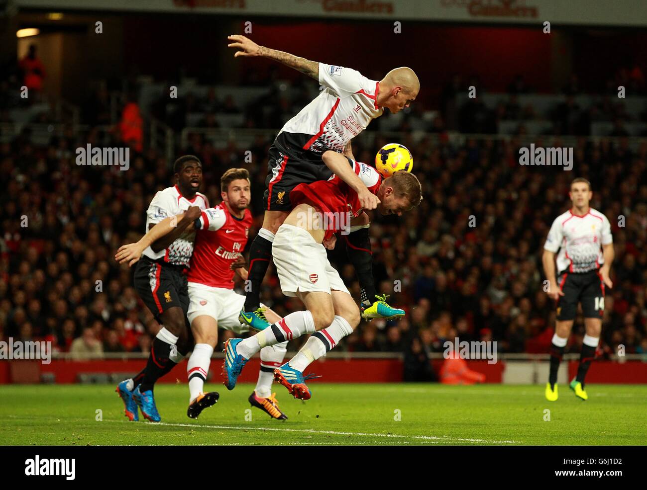 Liverpool's Martin Skrtel (top) and Arsenal's Per Mertesacker battle ...