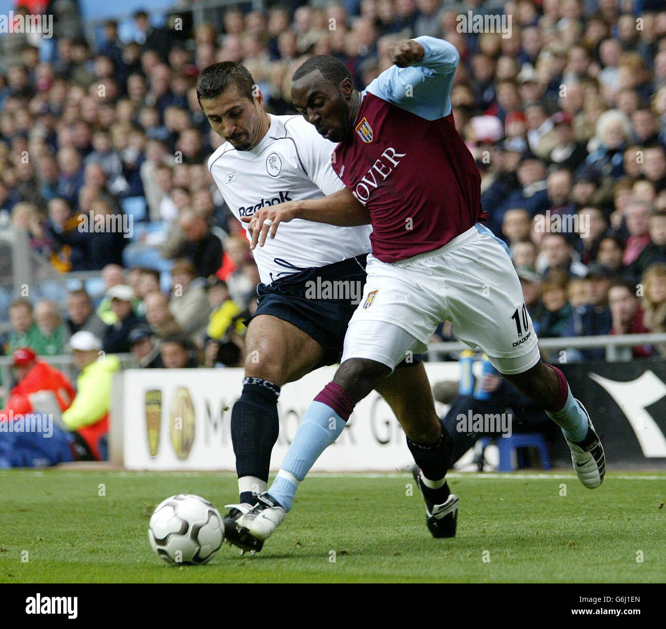 Aston Villa's Darius Vassell tussles with Bolton Wanderers' defender ...