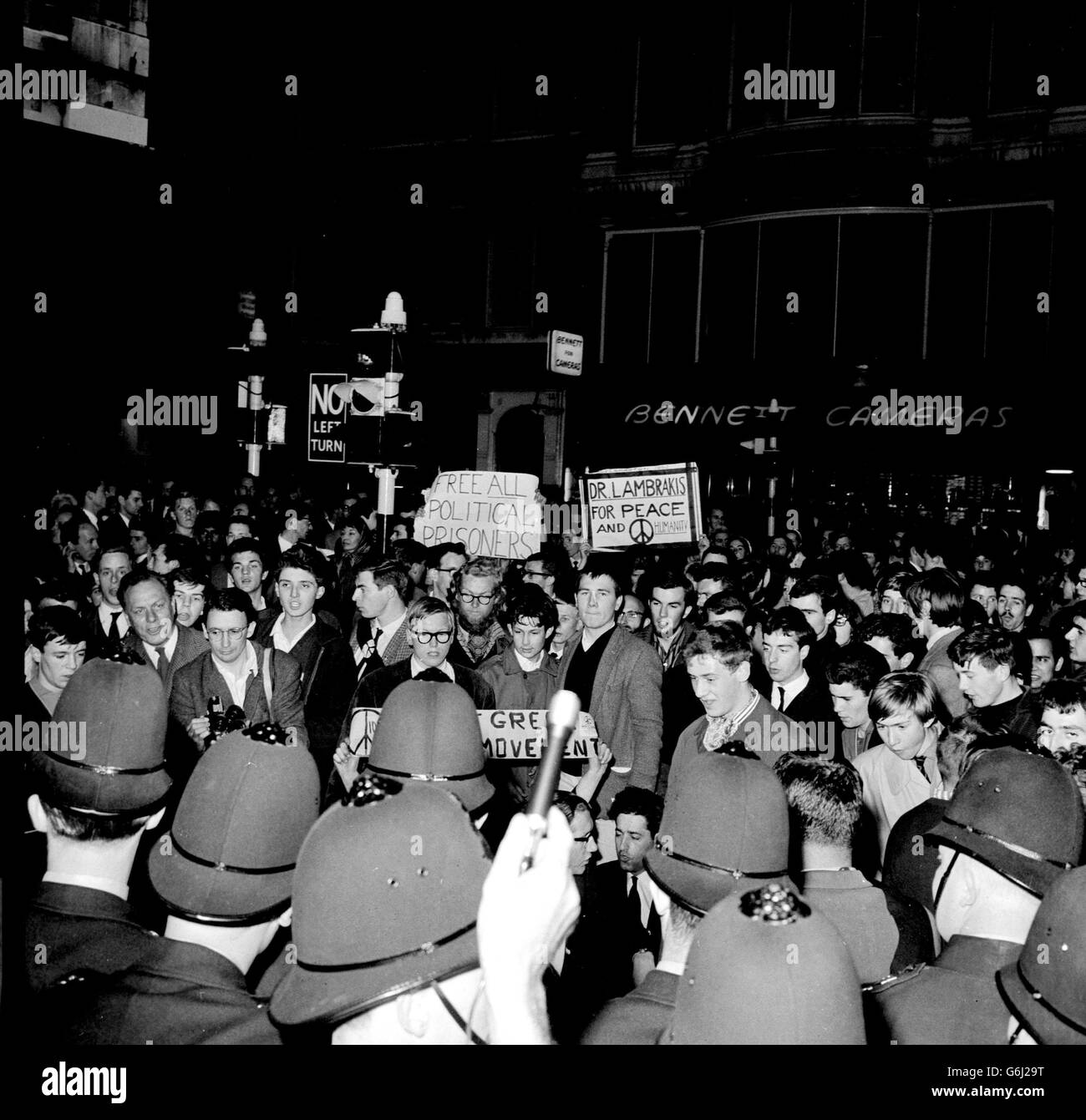 Police try keep back demonstrators attempting force way through ...