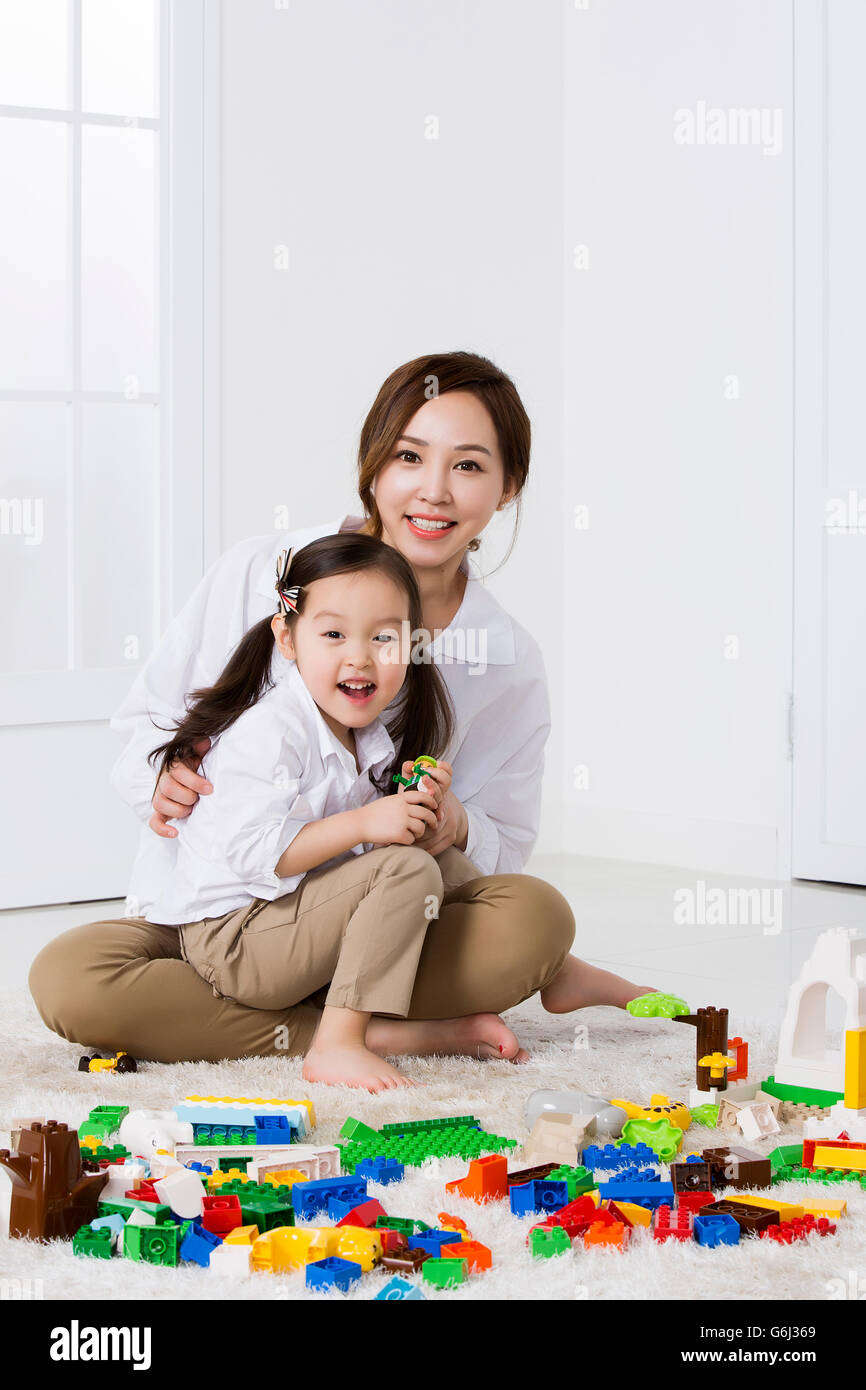 Asian Mother and Daughter Playing with Building Blocks at Home Stock ...