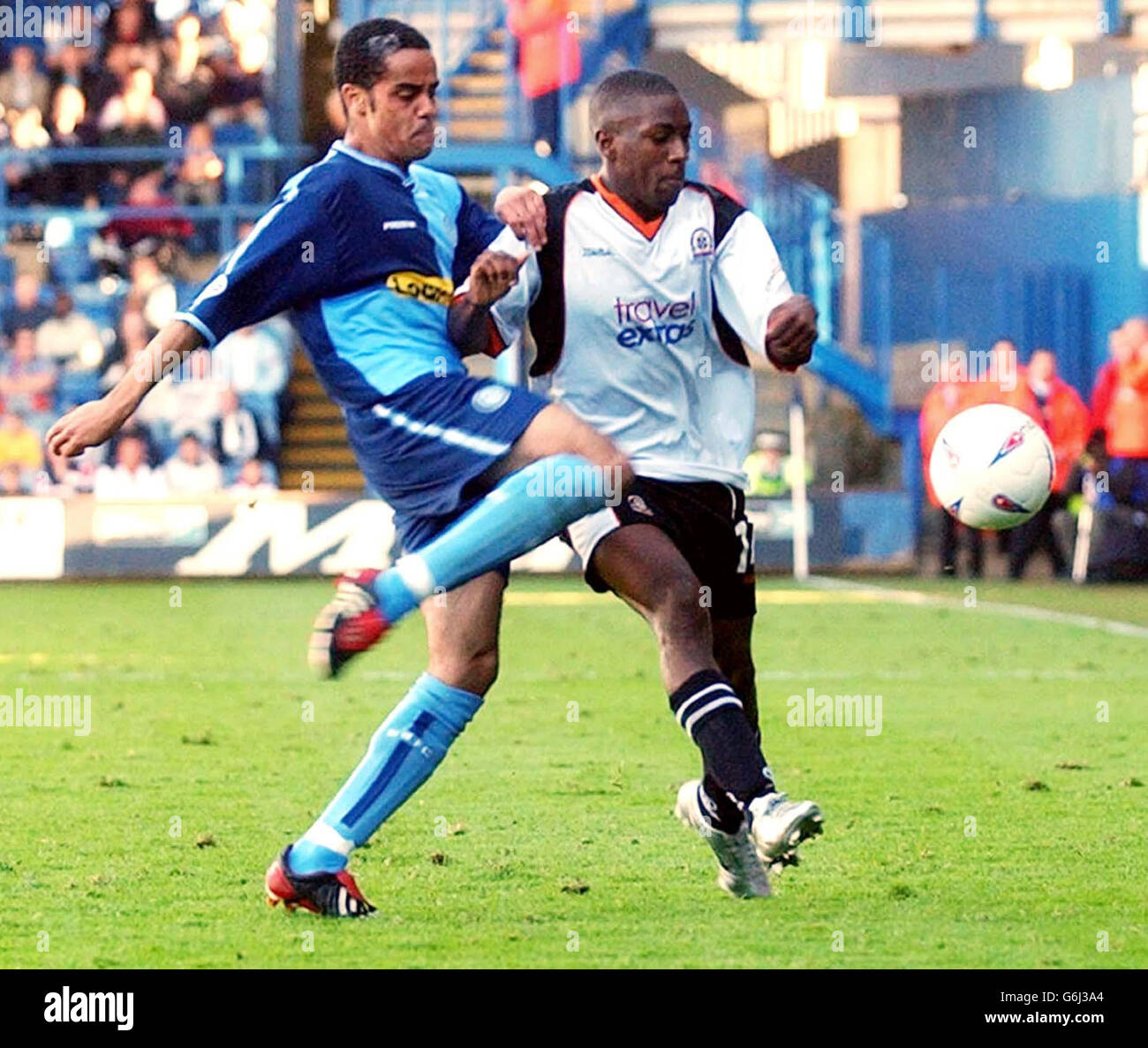 Wycombe's Daniel Senda (L) challenges Luton's Courtney Pitt during ...