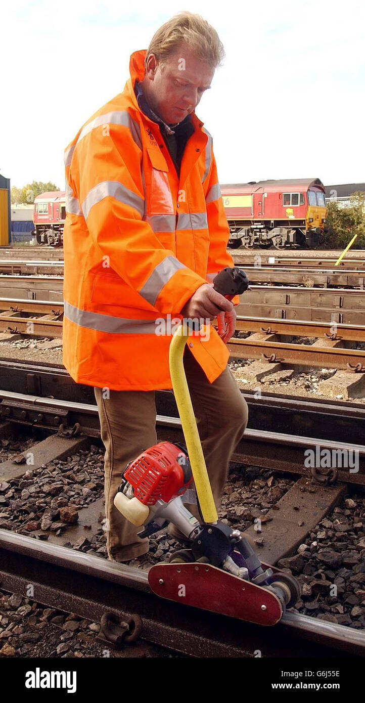 A hand operated motorised track grinder, is used to help solve the ...