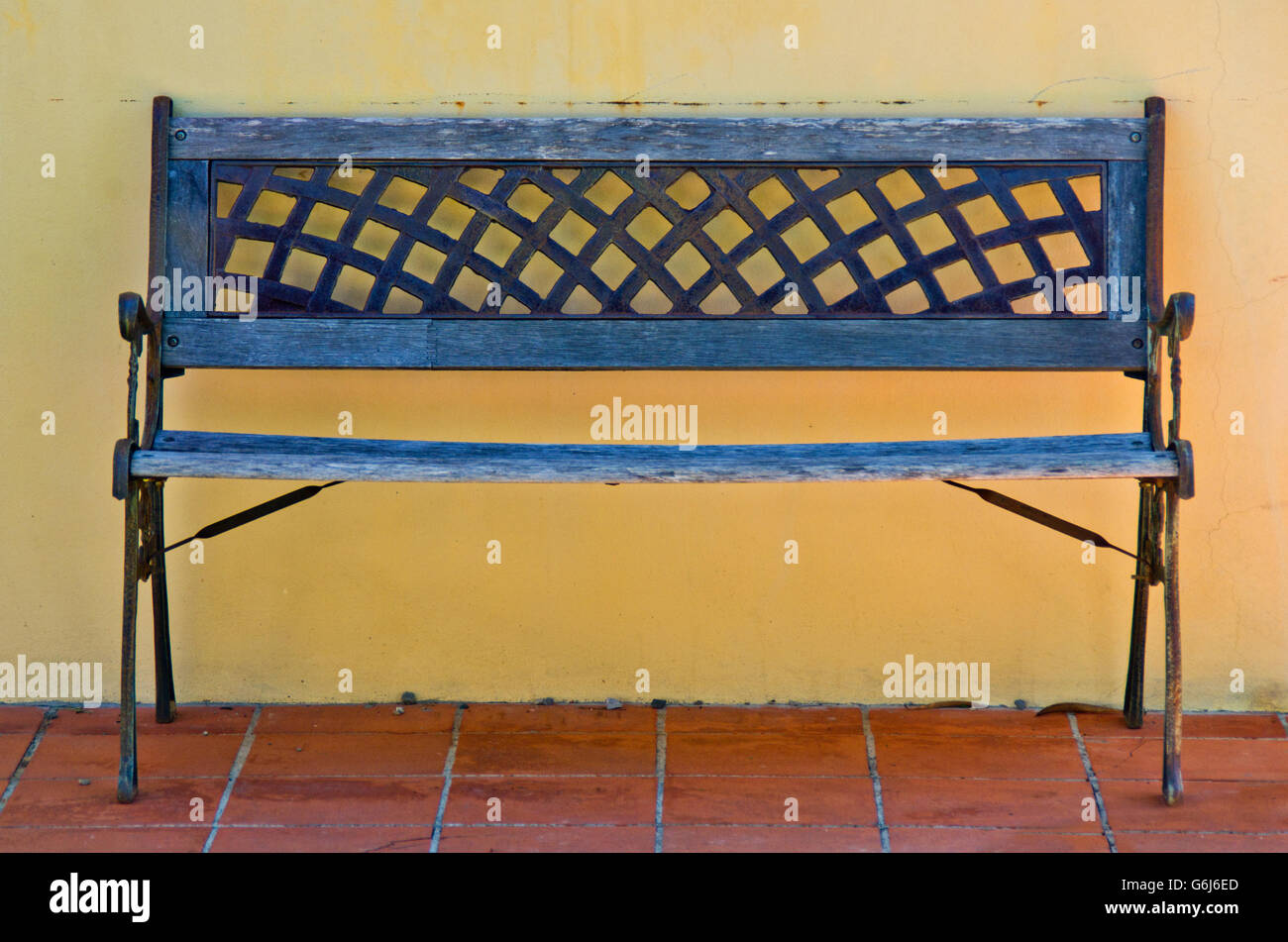 old decorated iron bench and worn wooden use and time Stock Photo - Alamy