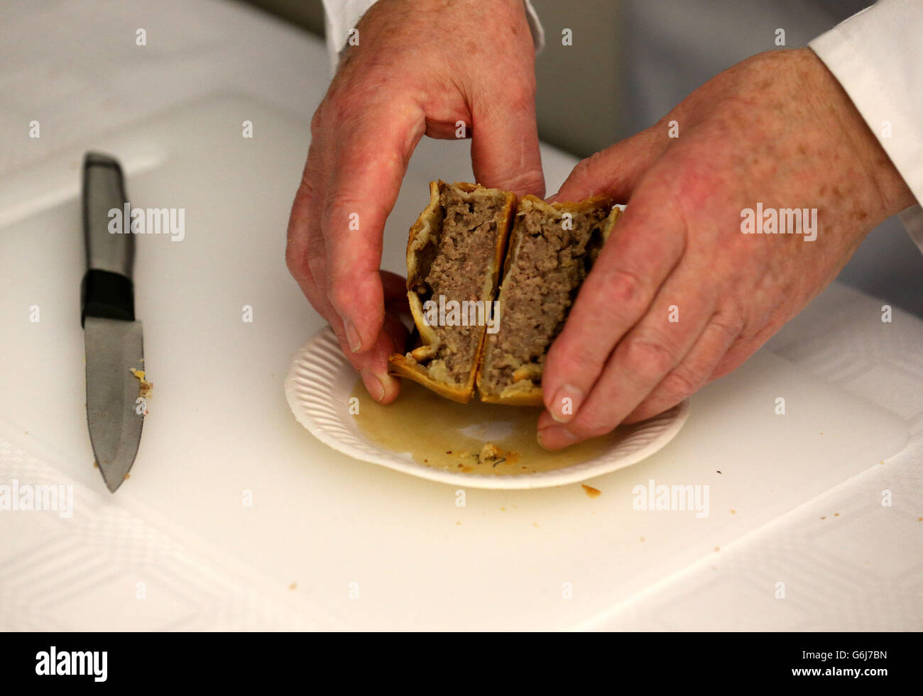 A Scotch pie is cut open during judging of the 15th World Scotch Pie ...