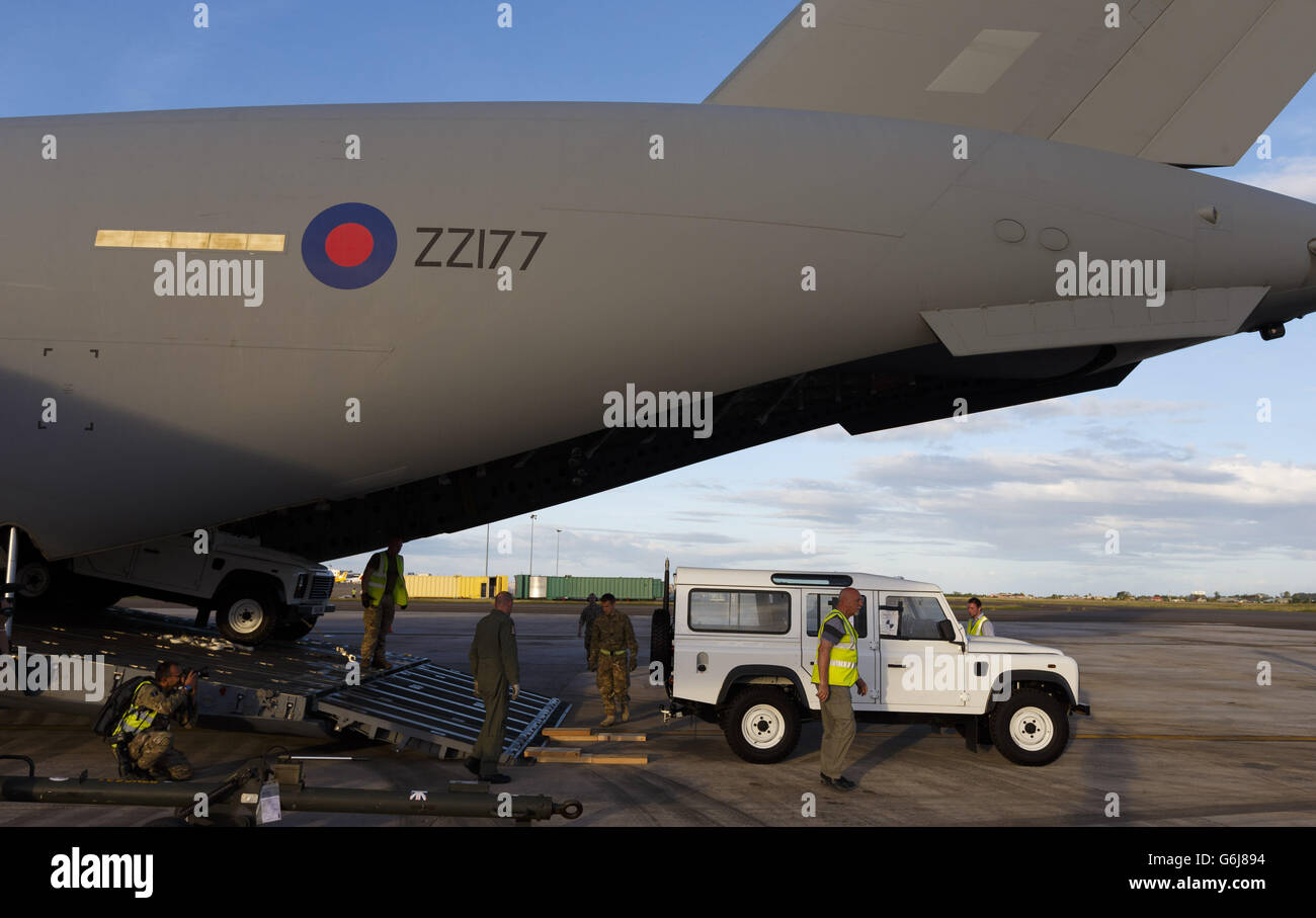 RAF ground crew unload emergency supplies of JCB diggers and Land ...
