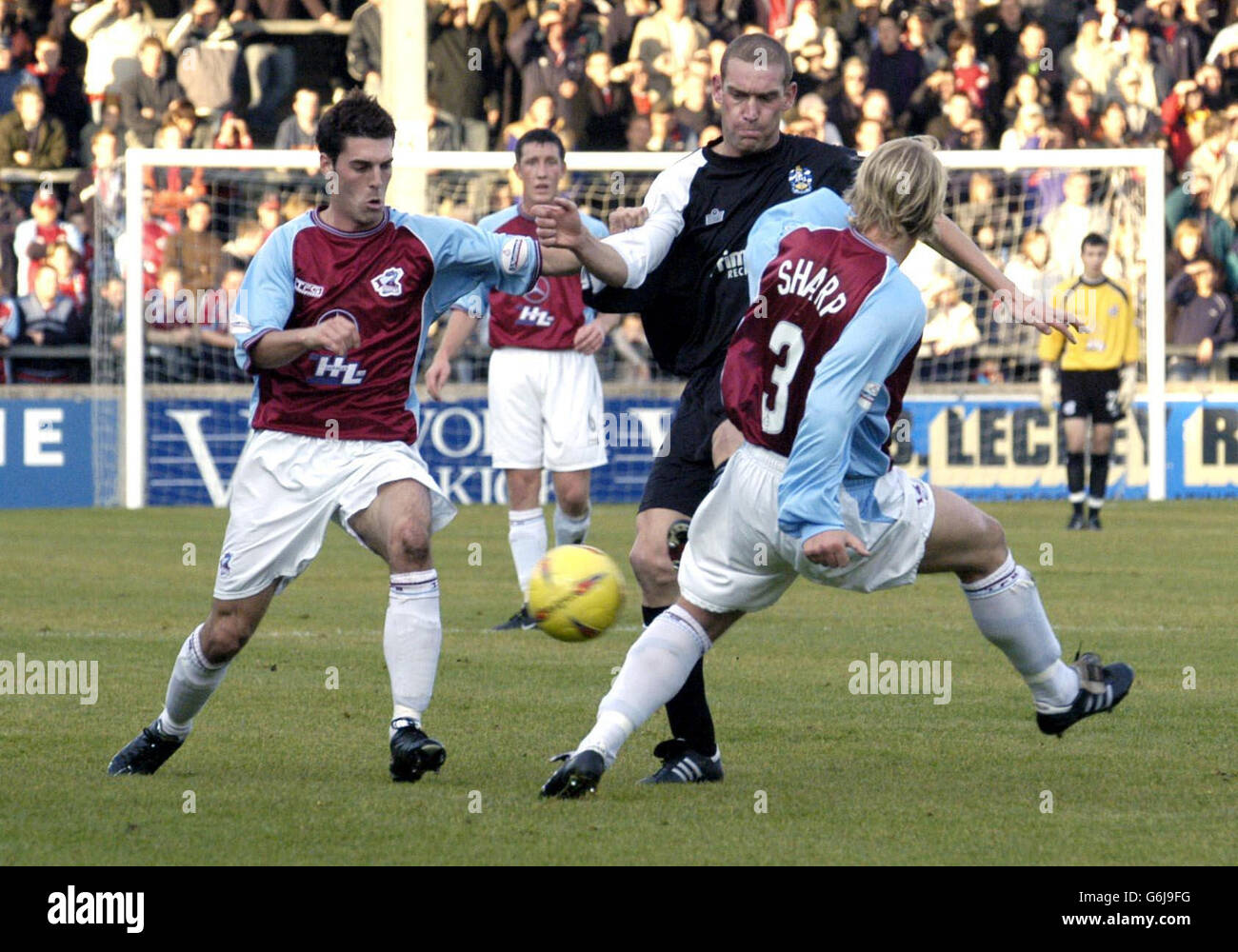 Huddersfield's Andy Booth (2nd from r) takes on Scunthorpe's Matt ...