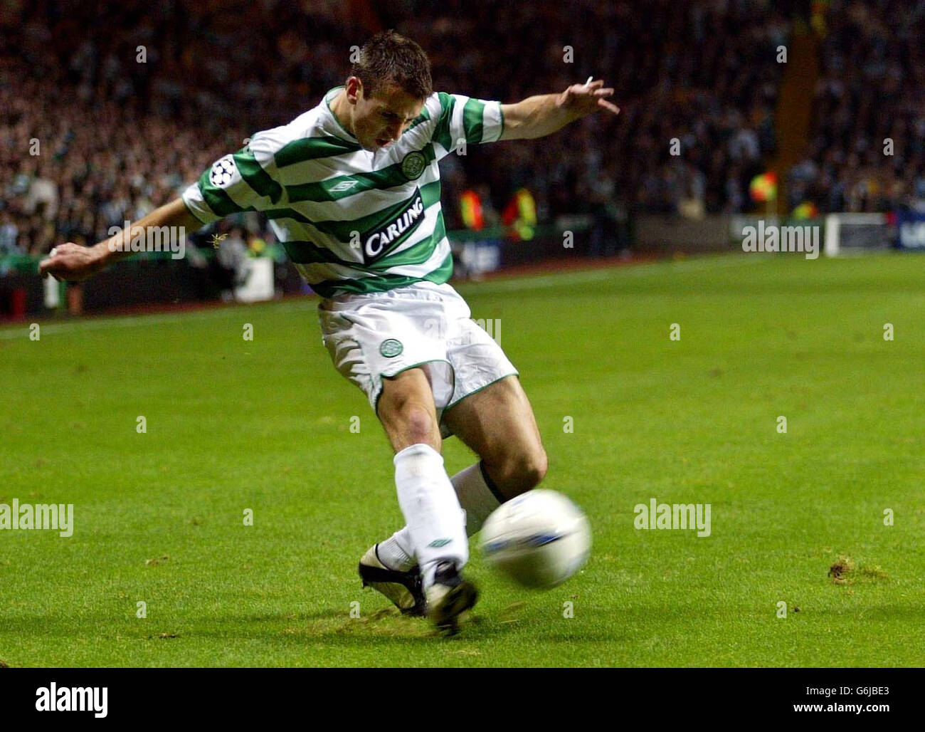 Liam Miller putting the ball past Anderlecht's goal keeper Daniel Zitka ...