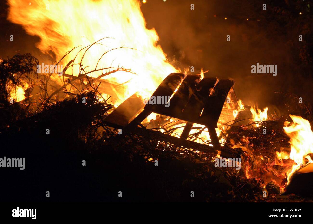 A picnic table burning on the bonfire at a fireworks display and ...